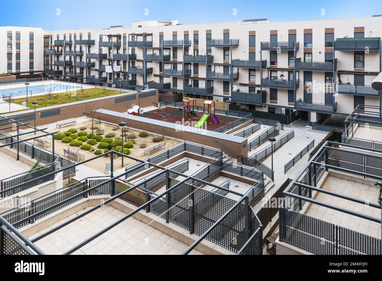 common areas of an urban housing development with gardens, children's ...