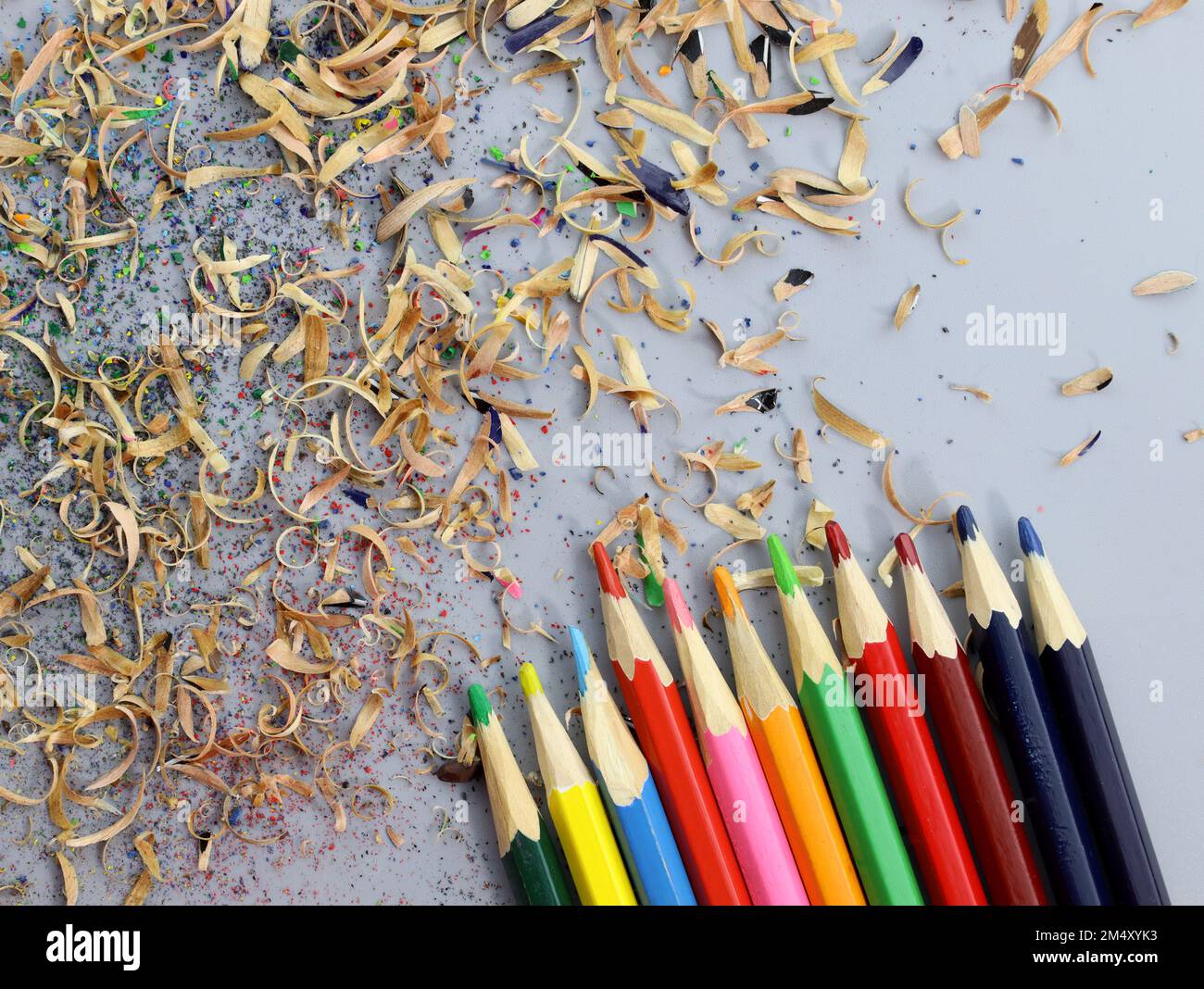 Colored pencils and shavings top view. Close-up drawing pencils ...