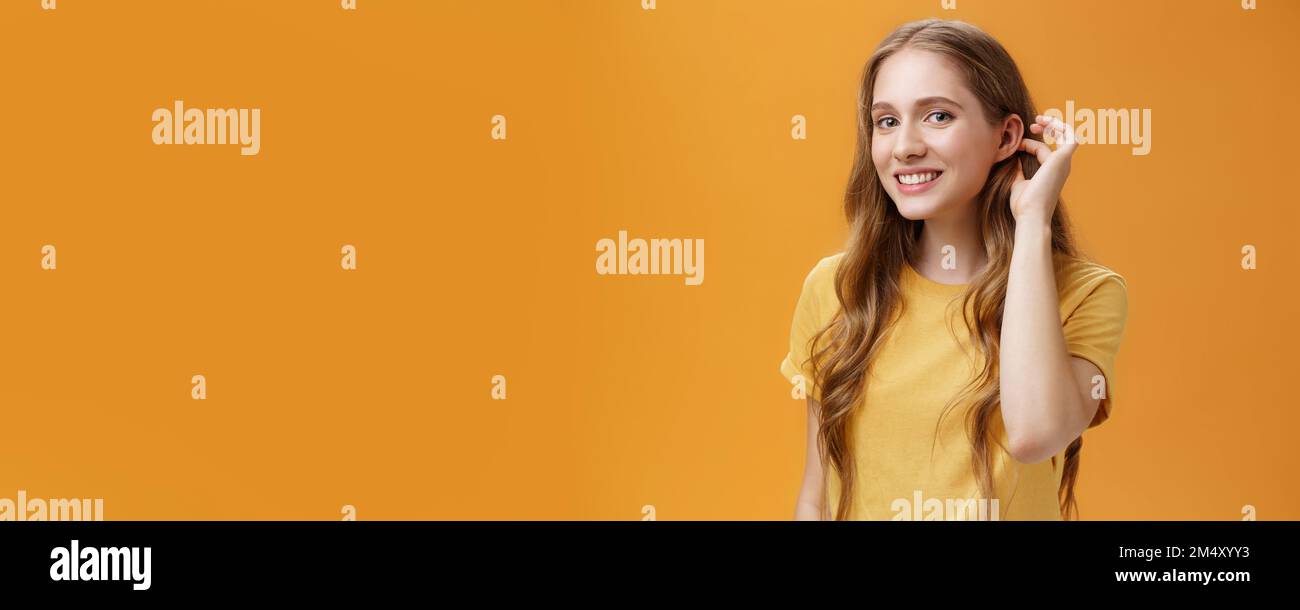 Cute and tender flirty young woman with cute wavy hairstyle flicking ...