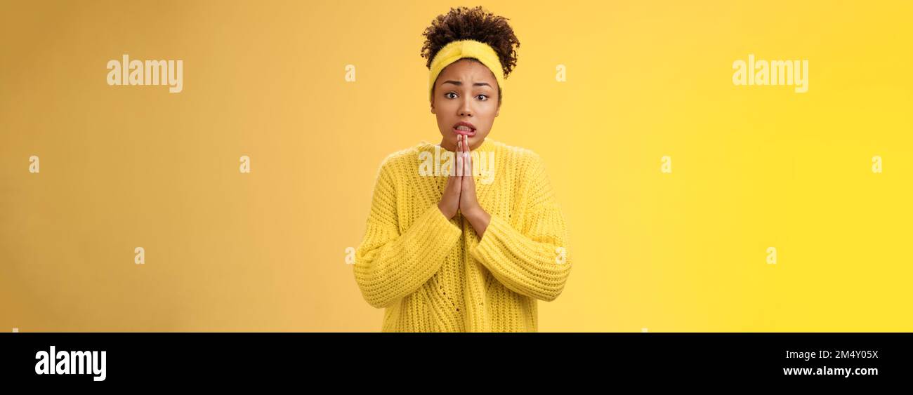 Intense worried perplexed young gloomy african-american woman hold ...