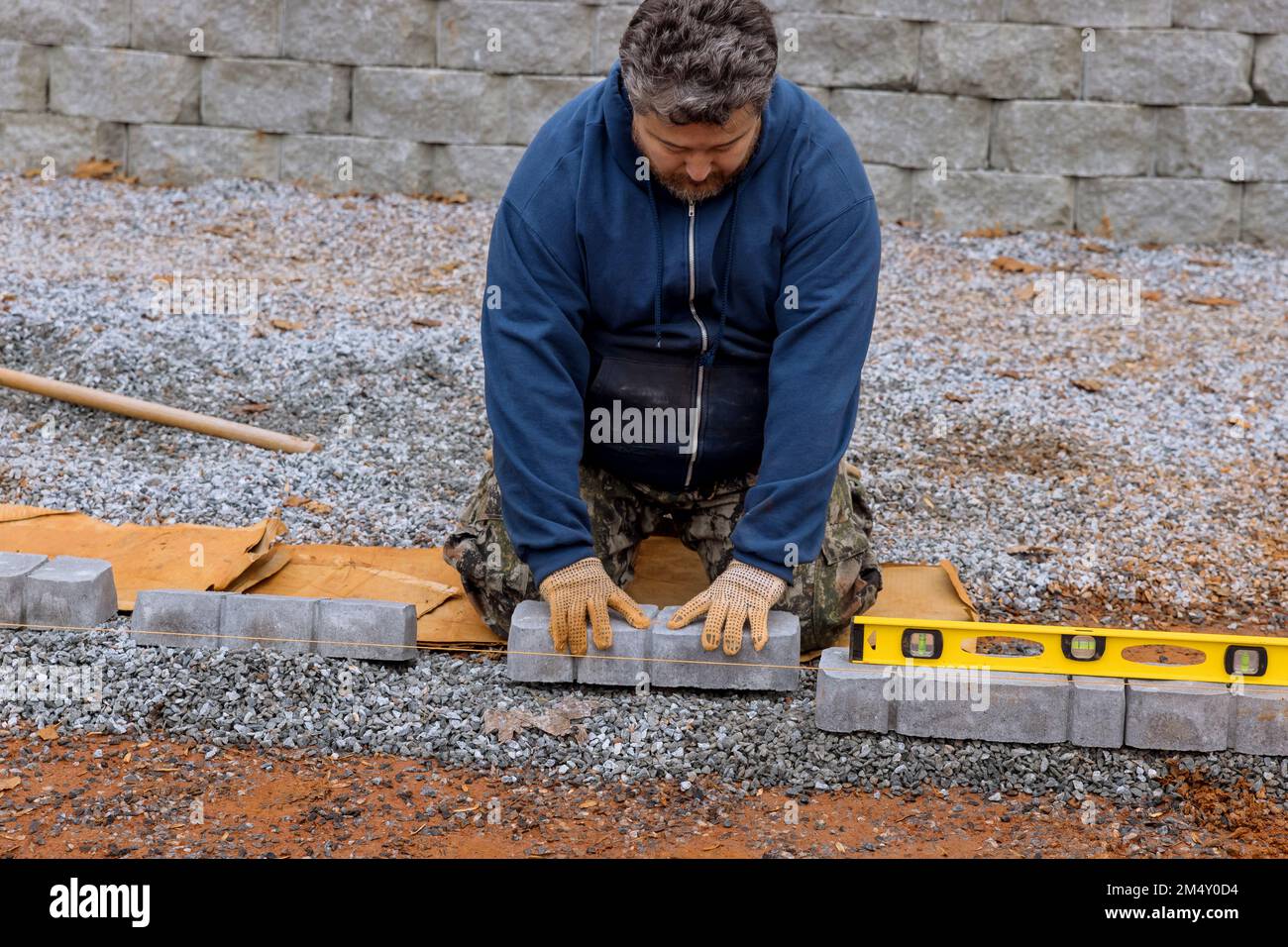 Construction workers for sidewalk consisting of stone concrete pavers ...