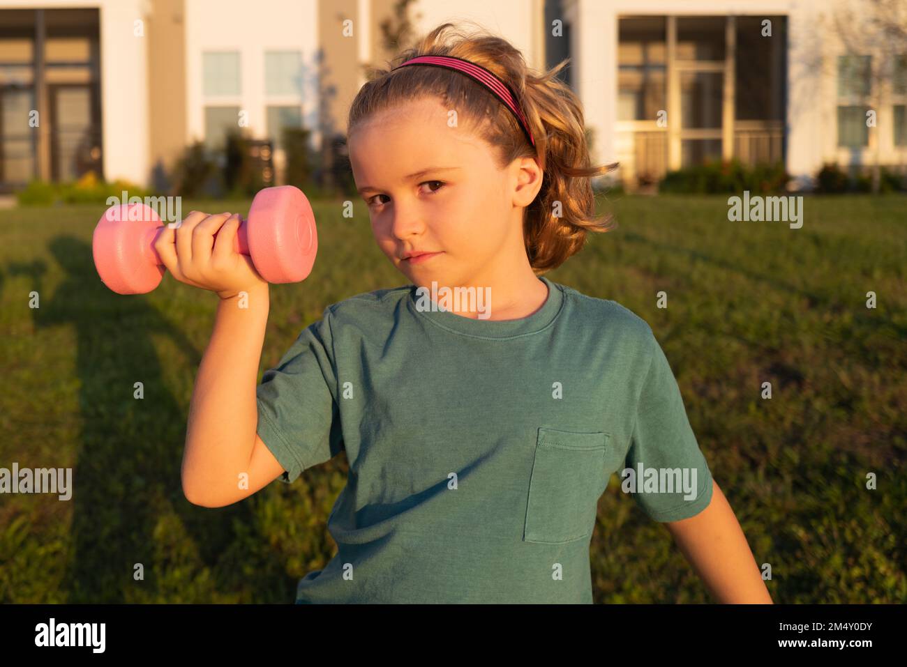 Kids sport training outdoor. Sport activities at leisure with children. Blonde boy holding ...