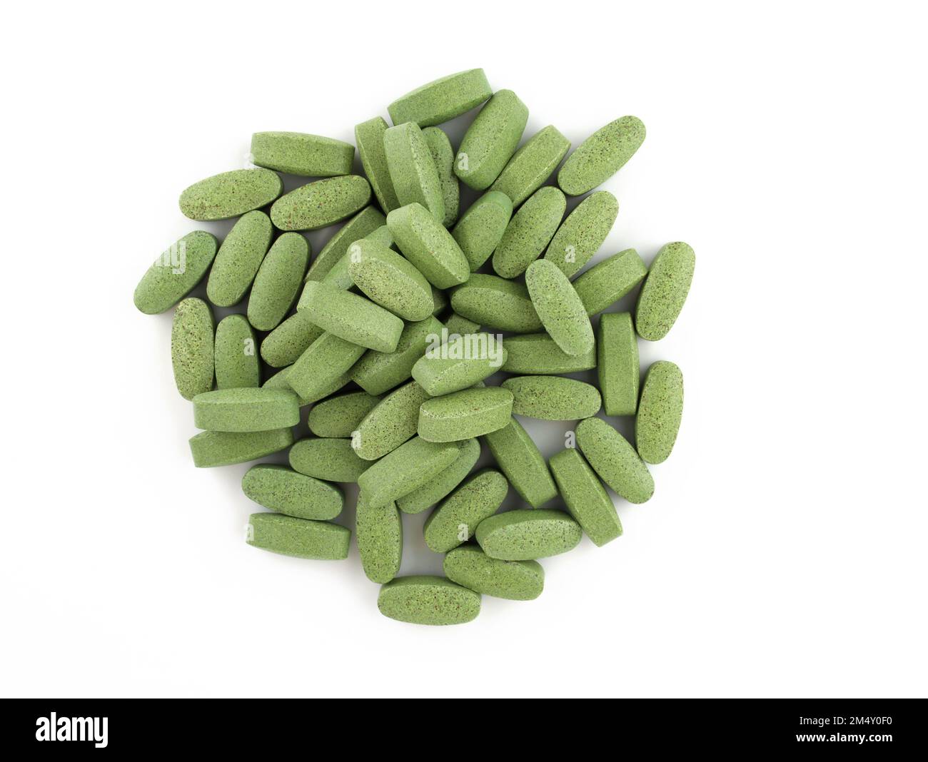 Green oval shaped pills on a white background. Tablets large spirulina ...