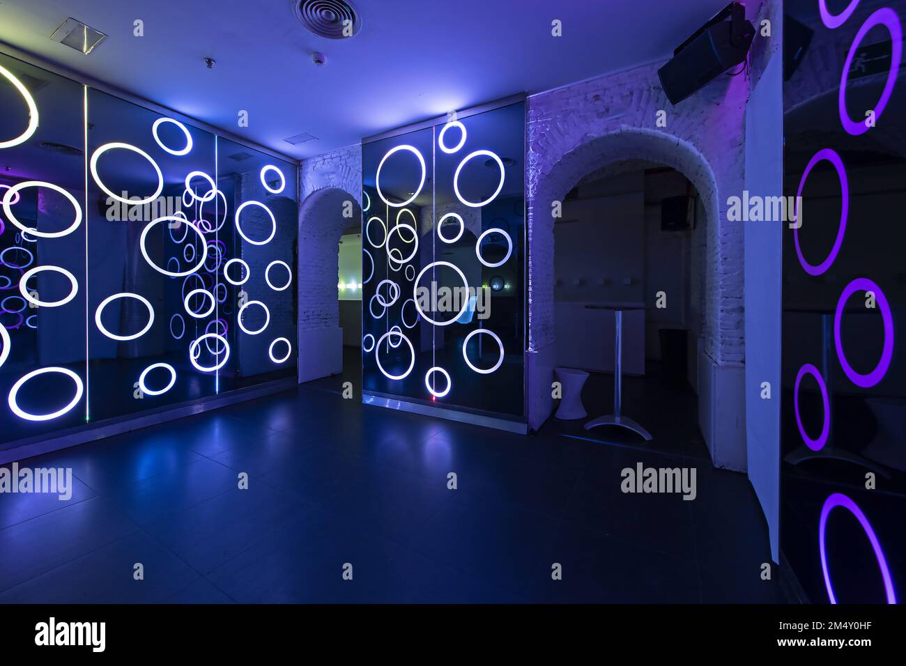 Room of a nightclub decorated with rgb led lights and accesses to other ...
