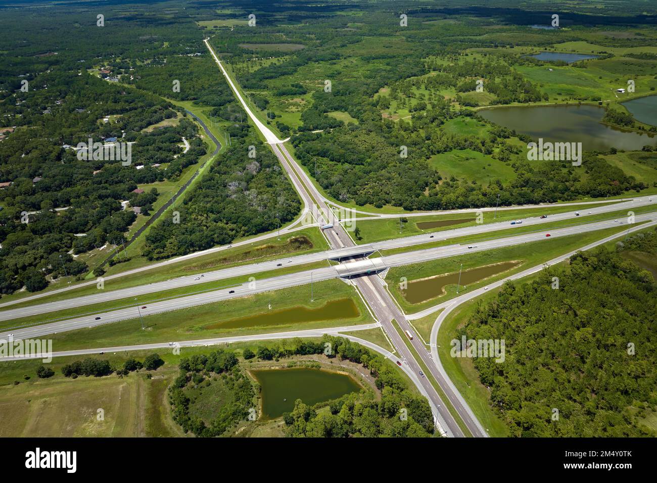 Aerial view of freeway overpass junction with fast moving traffic cars ...