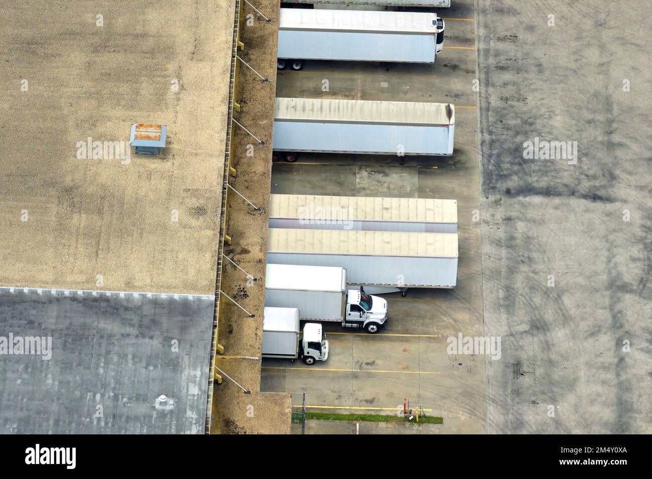 Aerial view of large commercial distribution center with many trucks ...