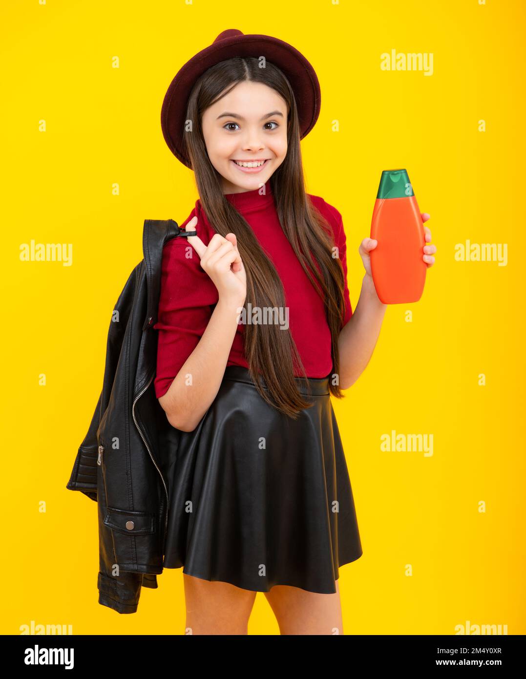 Teenager child girl showing bottle shampoo conditioners or shower gel ...