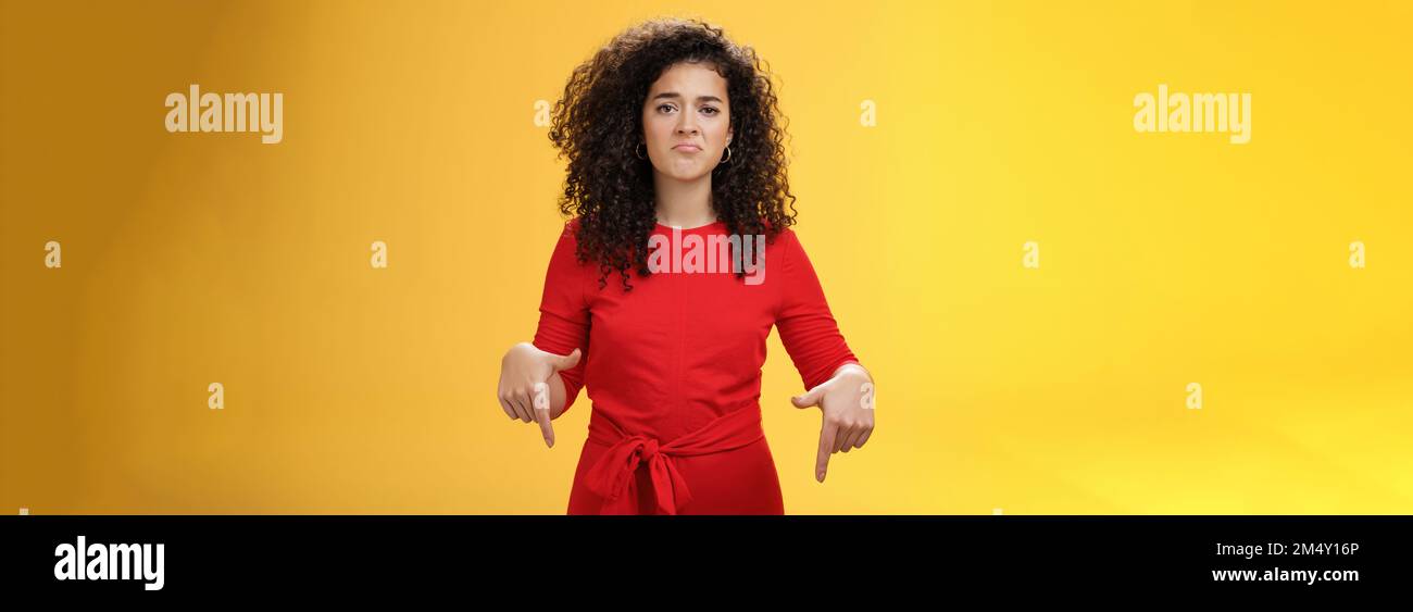 Portrait of gloomy girl with sad face pursing lips down frowning ...