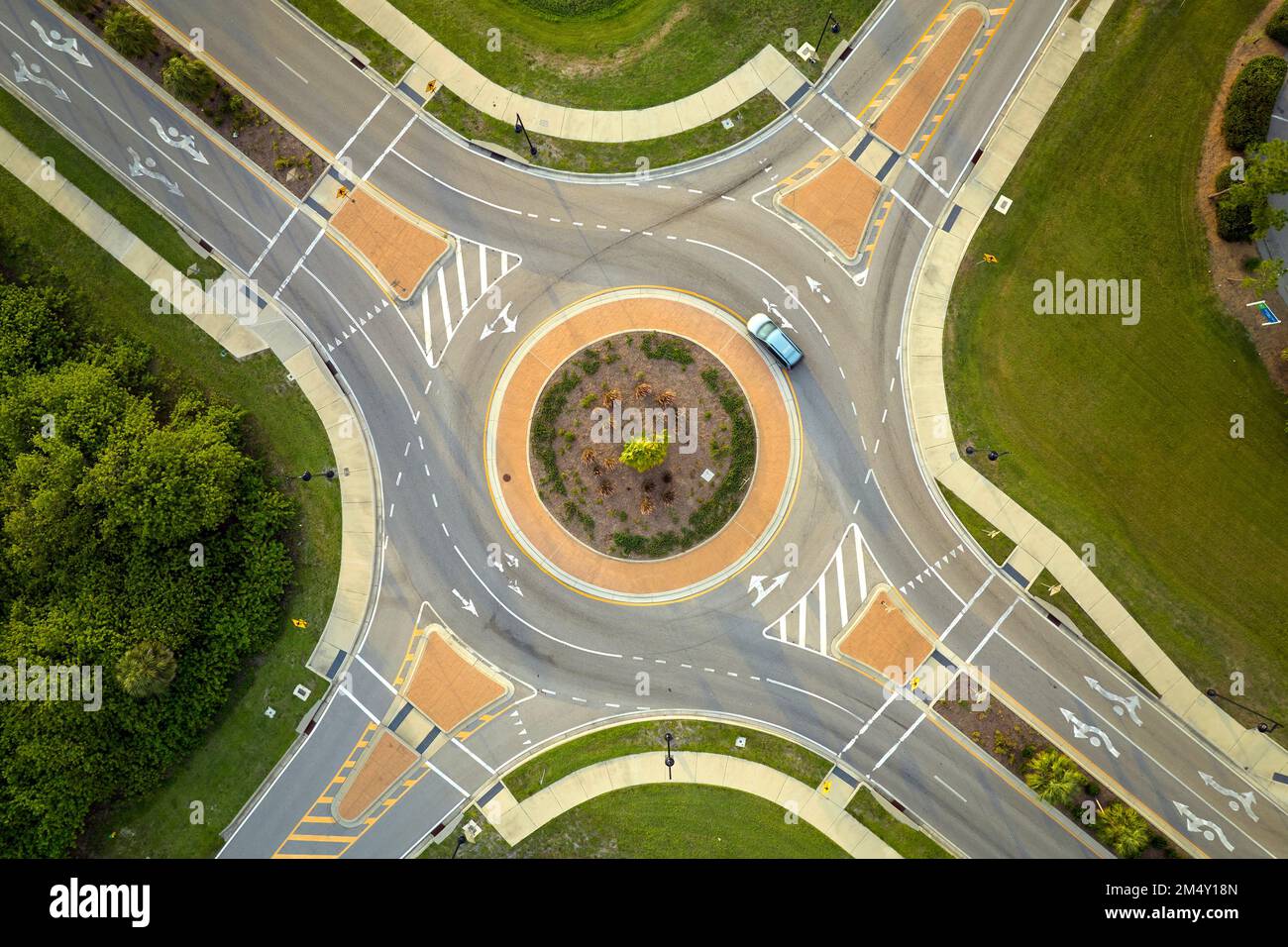 Aerial view of road roundabout intersection with moving cars traffic ...