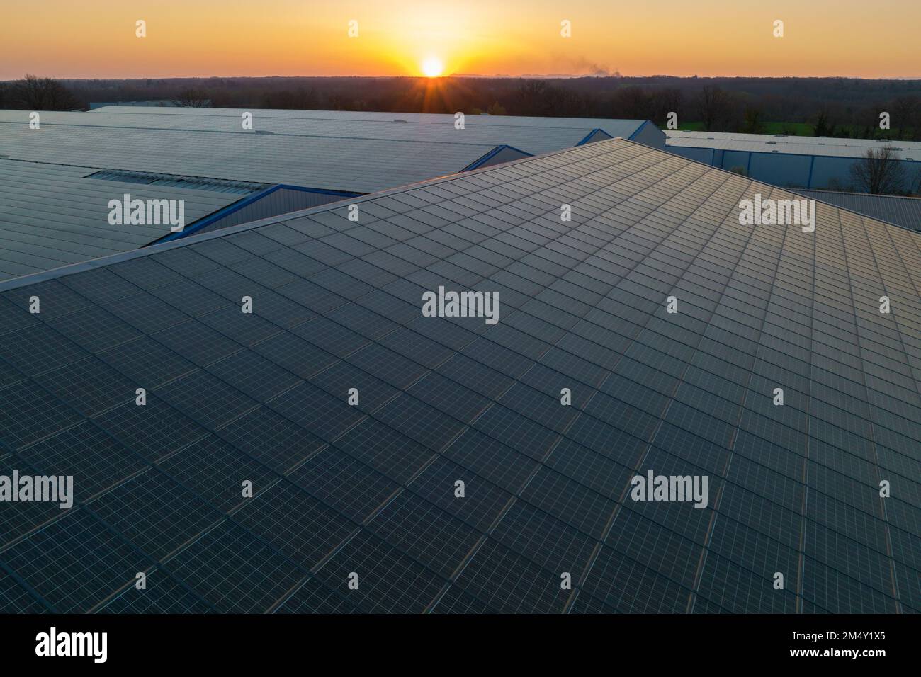 Blue photovoltaic solar panels mounted on building roof for producing ...