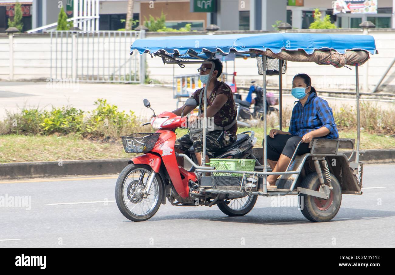 RATCHABURI, THAILAND, NOV 16 2022, A pair ride a motorcycle with a ...
