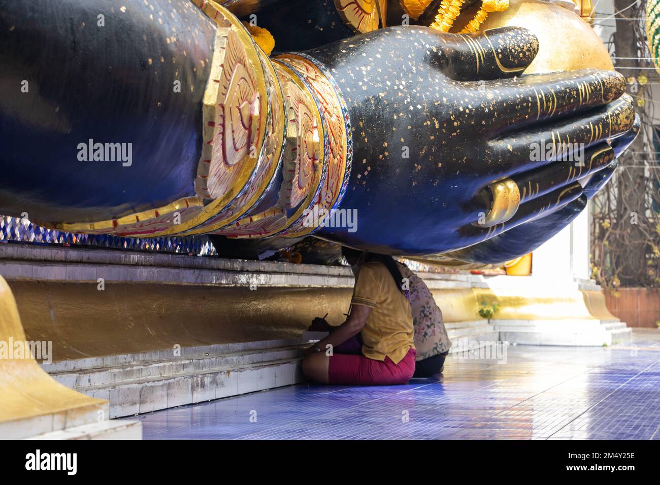 The mythological character Phra Rahu at Buddhist temple with believers ...