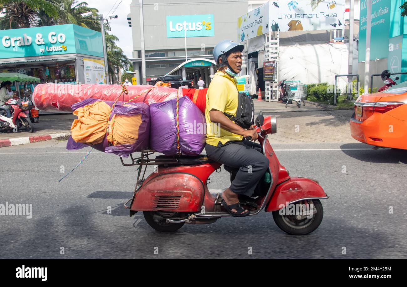 BANGKOK, THAILAND, DEC 06 2022, A motorcycle with a heavy load is ...
