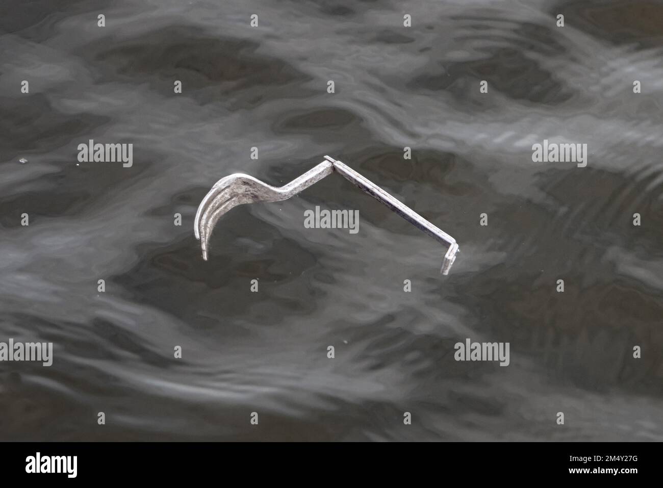 A plastic fork floats in the water Stock Photo - Alamy