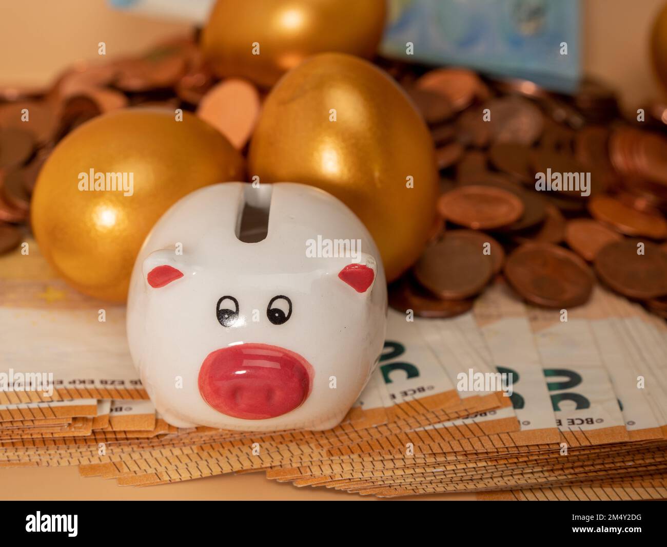 Golden eggs and piggy bank on money. Golden chicken eggs on euro ...