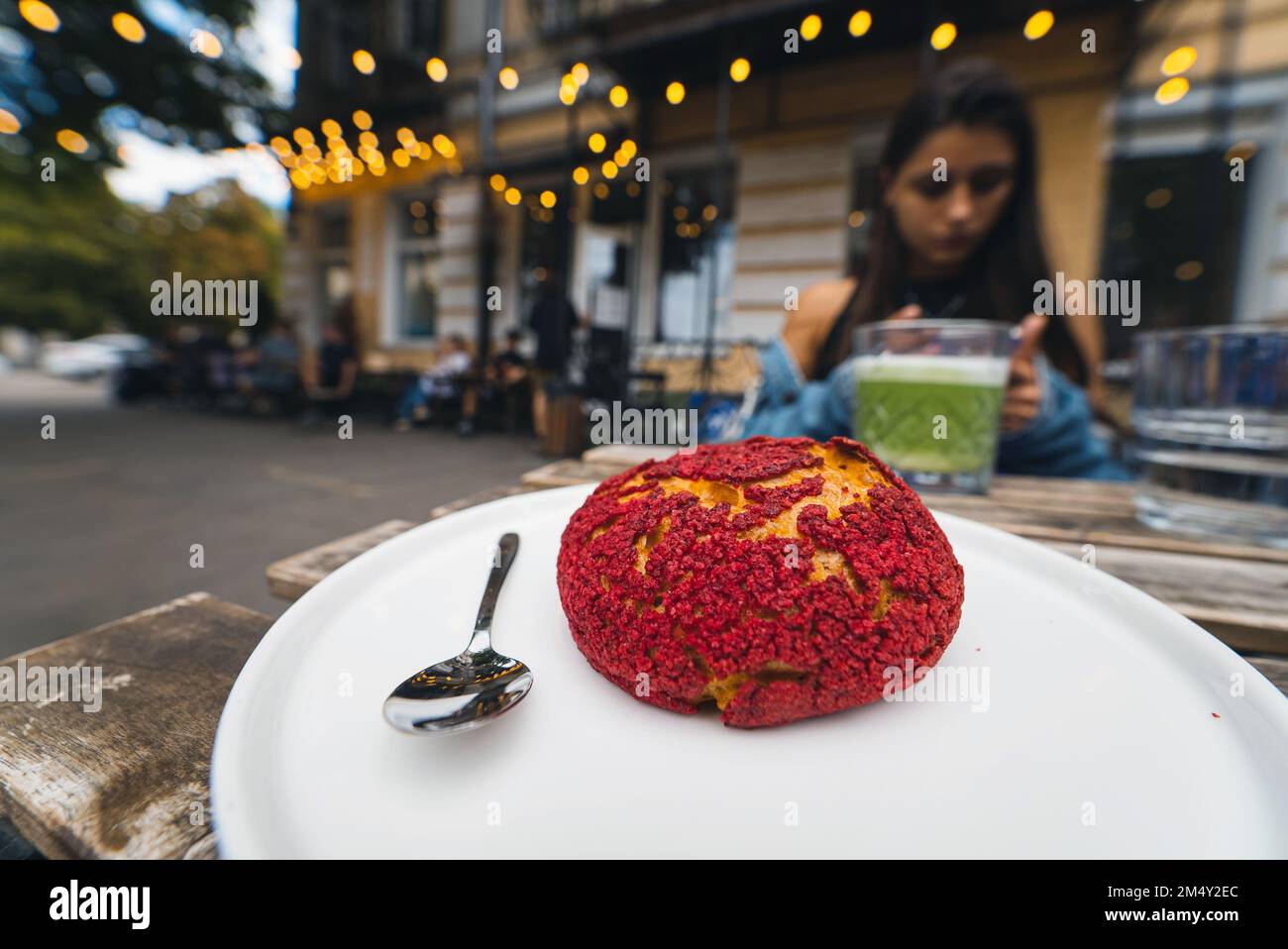 Delicious Cake shu eclairs with red strawberry crumble on table Stock ...
