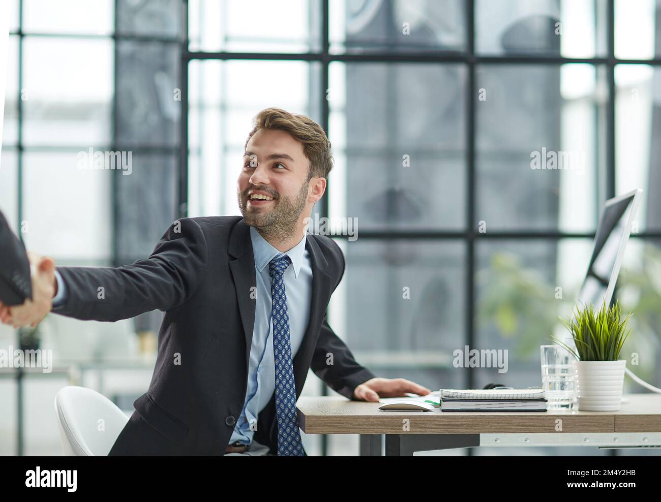 Hello by Man in Office, Indoor Waving Hand Stock Photo - Alamy