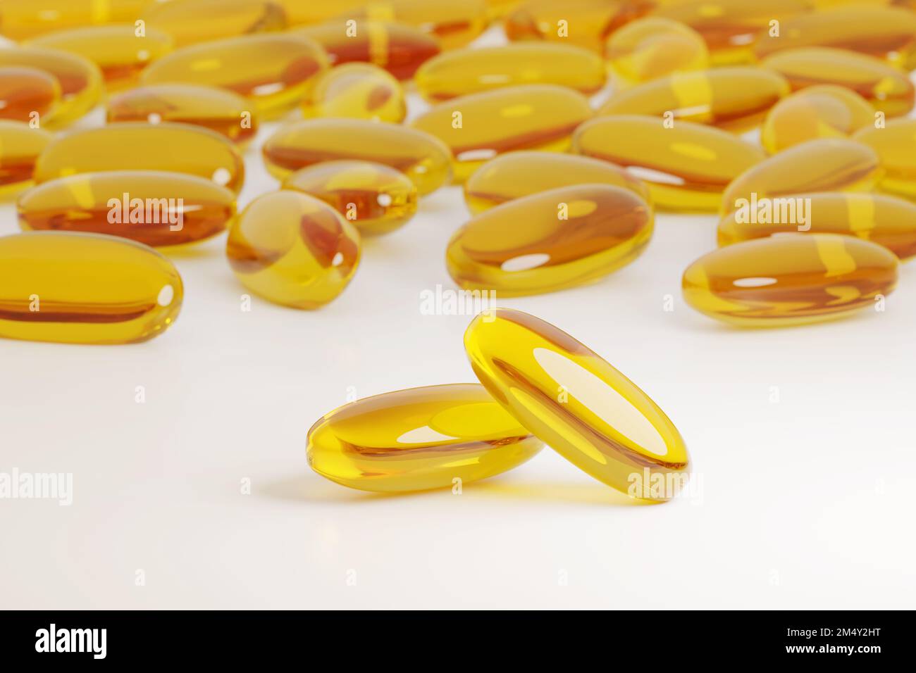 Yellow translucent cod liver oil pills scattered on white background ...