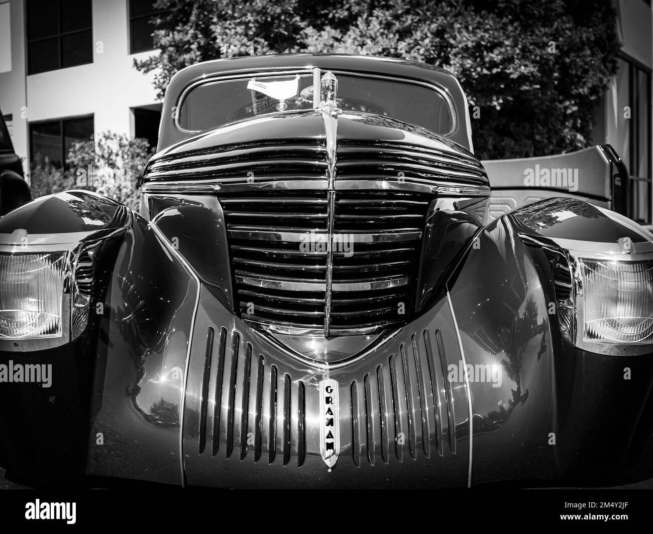 A closeup shot of a shiny black 1939 Graham Sharknose Coupe at Classic ...
