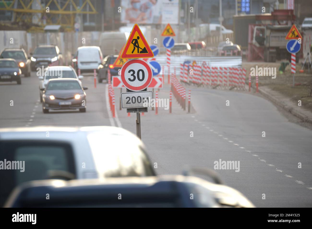 Roadworks warning traffic signs of construction work on city street and ...