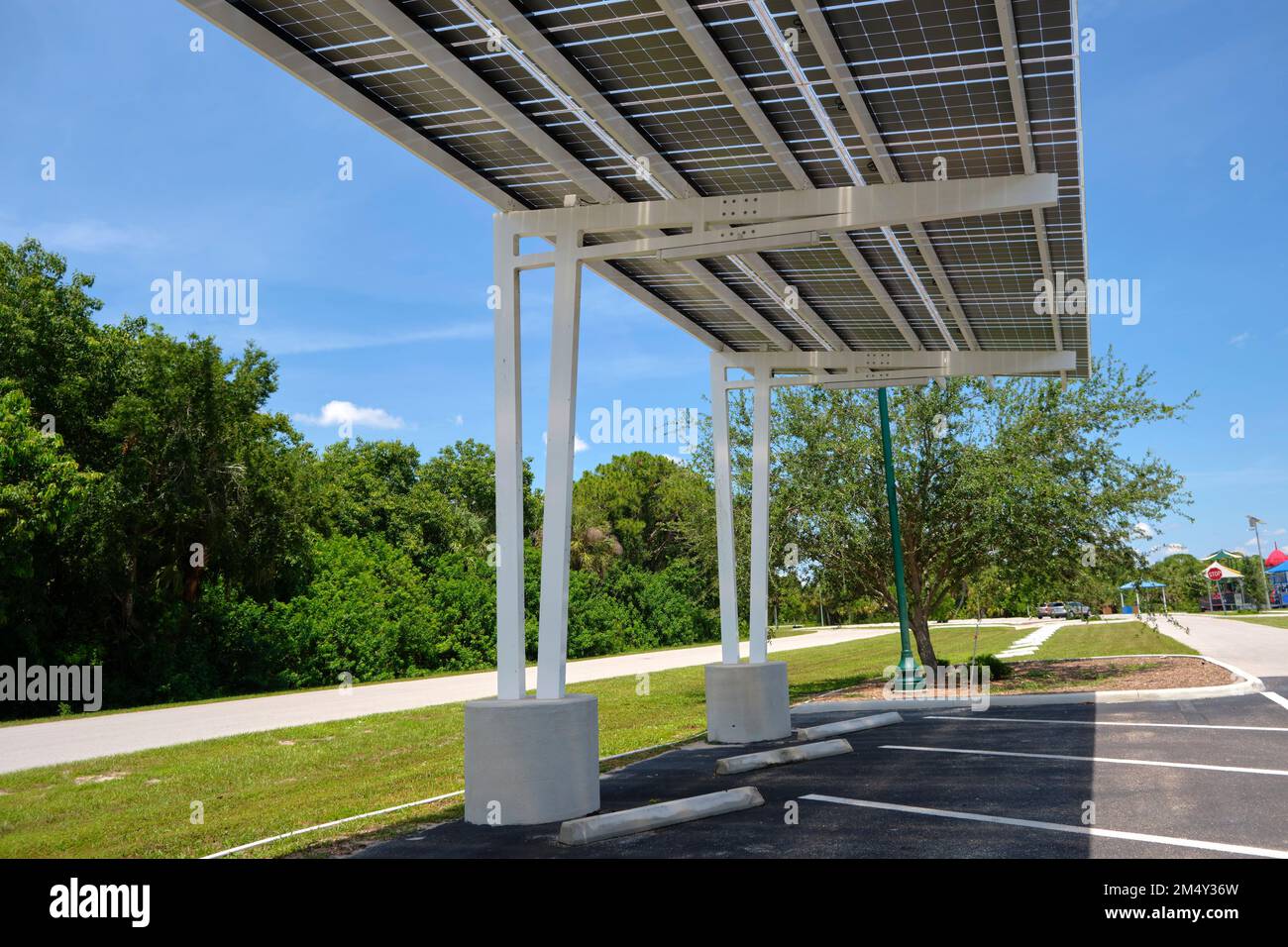 Solar panels installed over parking lot canopy shade for parked cars ...
