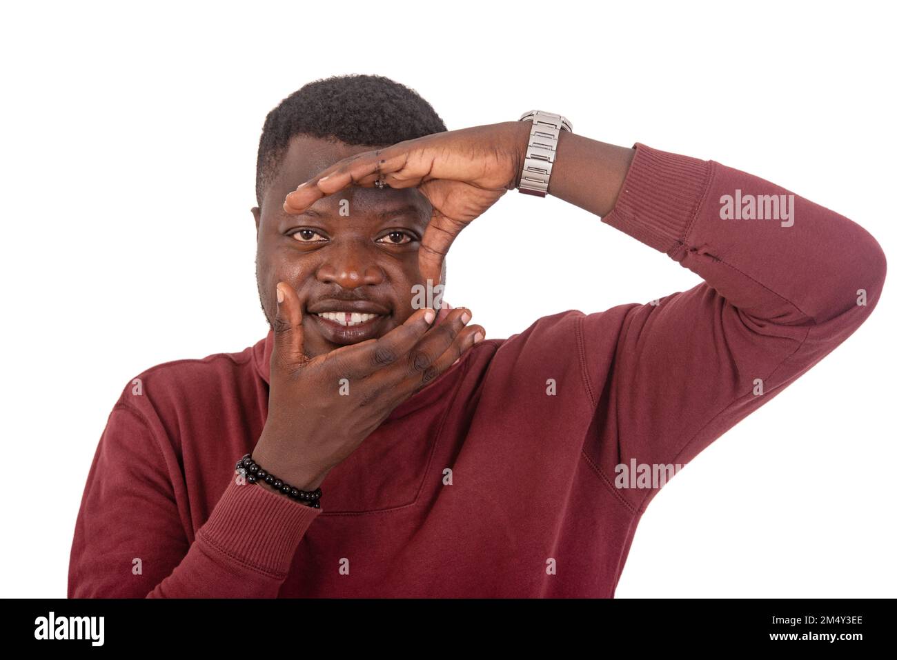portrait of a handsome young man making a face with hands near the face ...