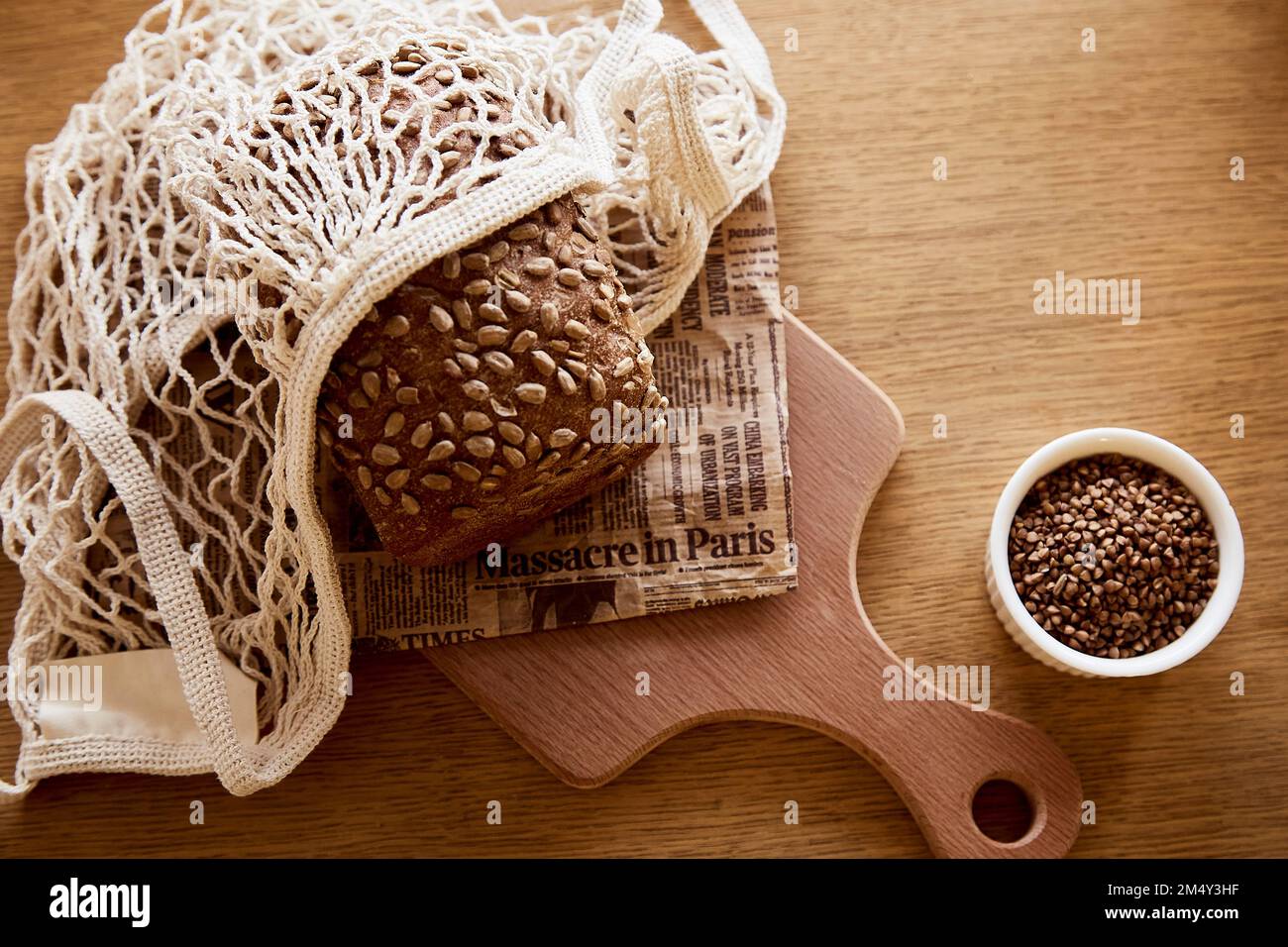 Unleavened buckwheat bread with sunflower seeds in eco mesh on wooden ...