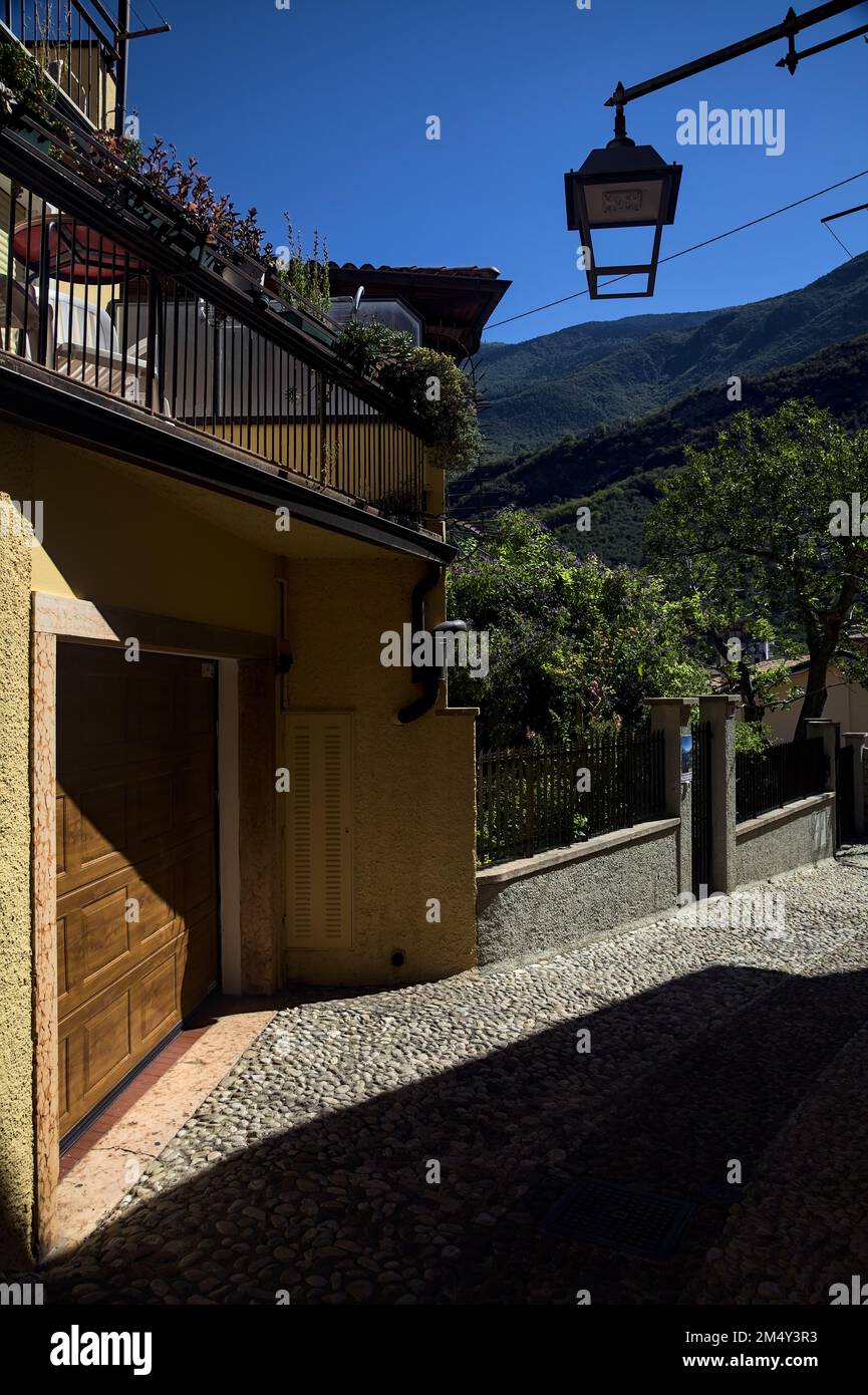 Narrow cobbled street that leads to a covered passageway in an old ...