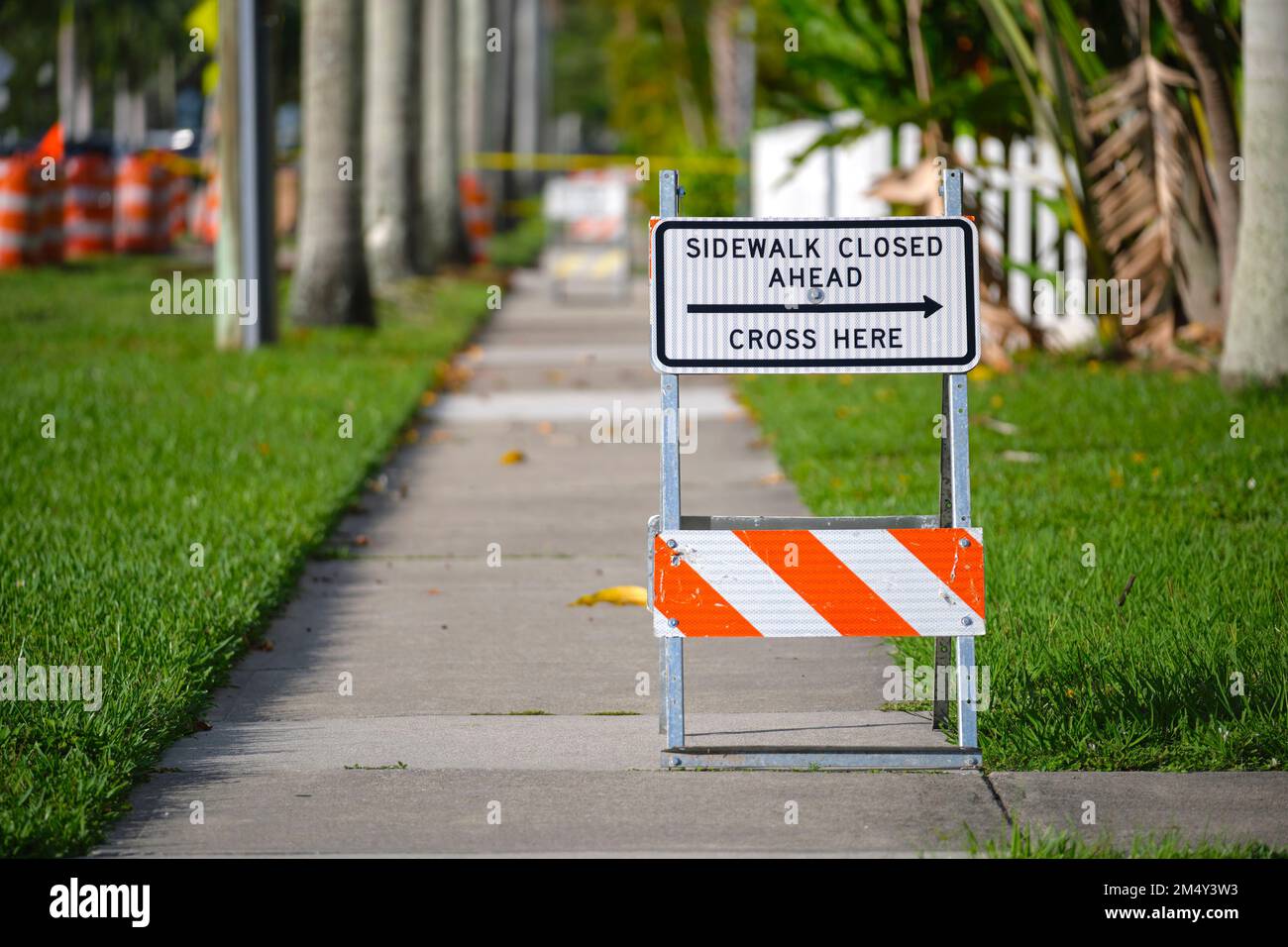 Warning sign that sidewalk is closed at street construction site ...