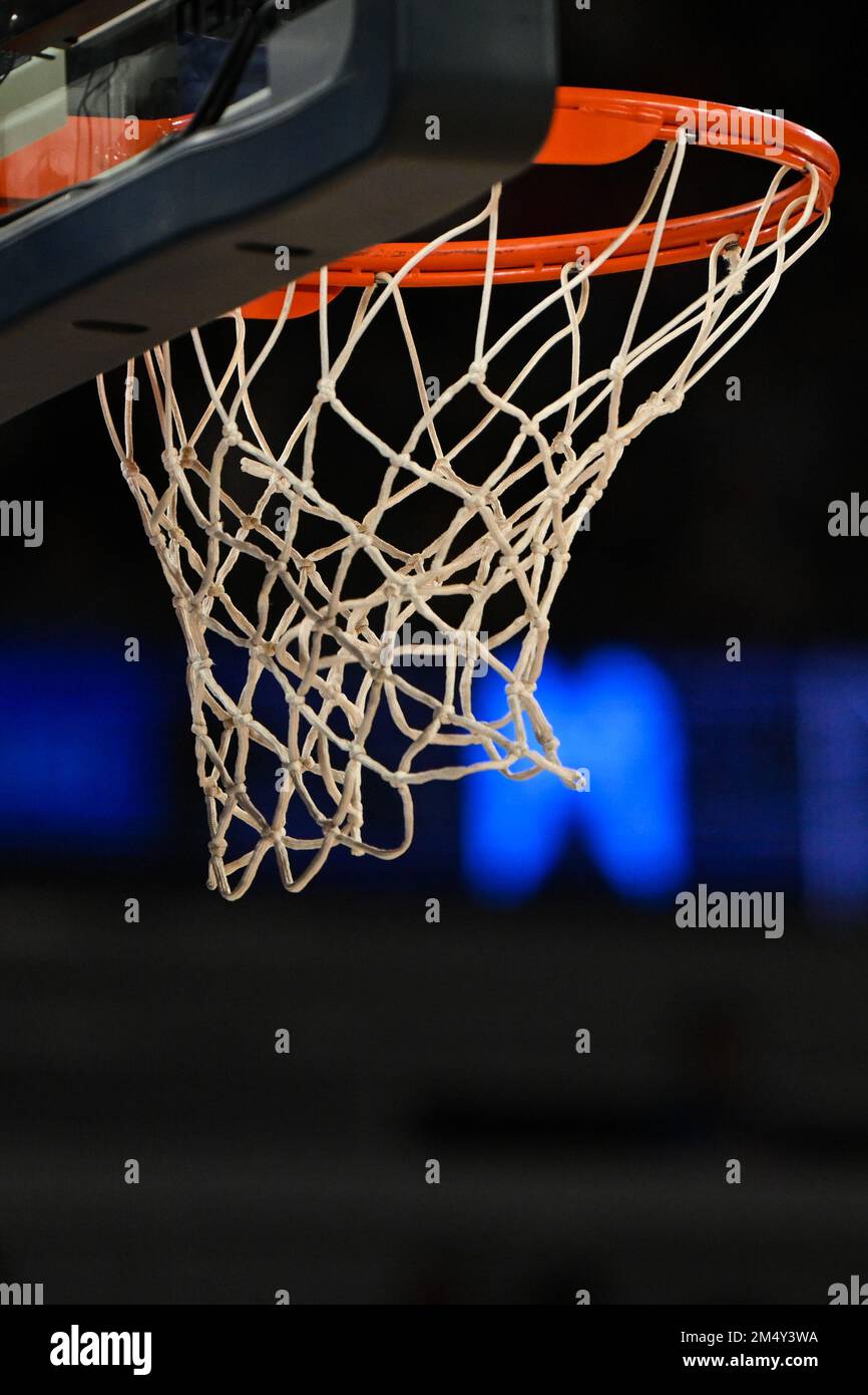 A close-up vertical view of a basketball ring of an indoor stadium ...
