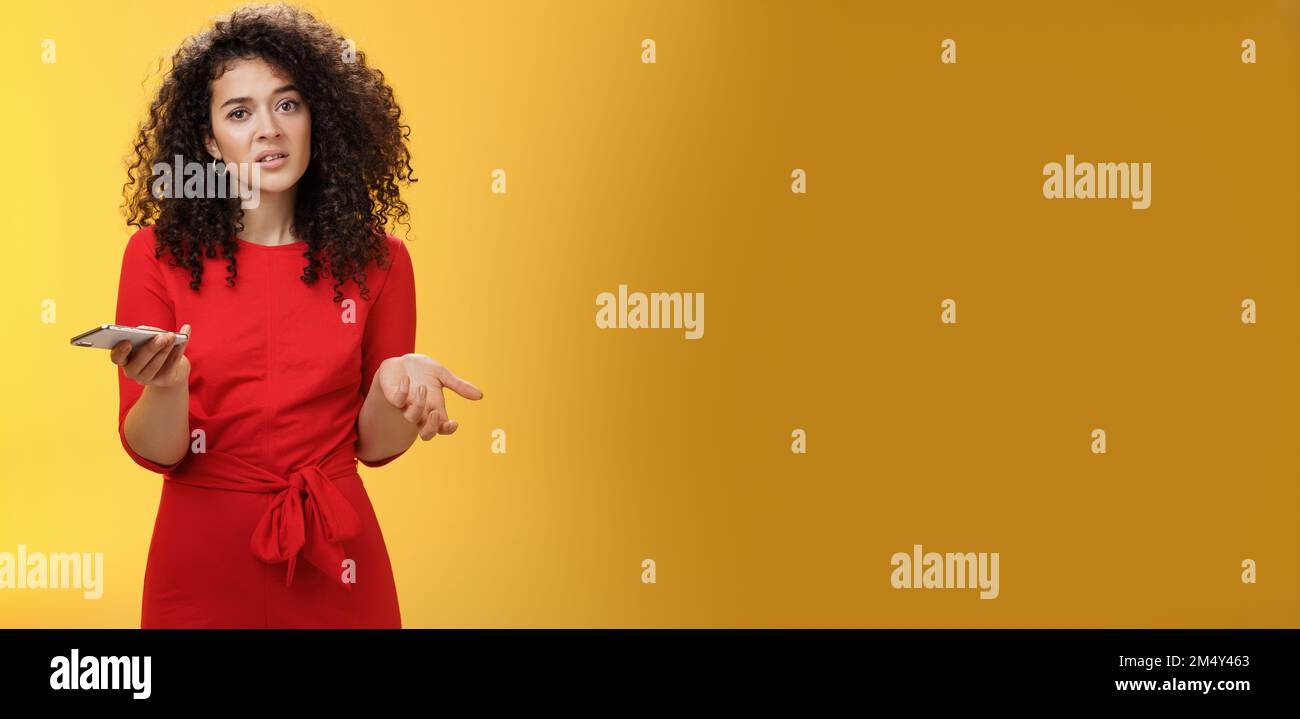 So waht, I confused. Questioned uncertain woman with curly hair in red ...