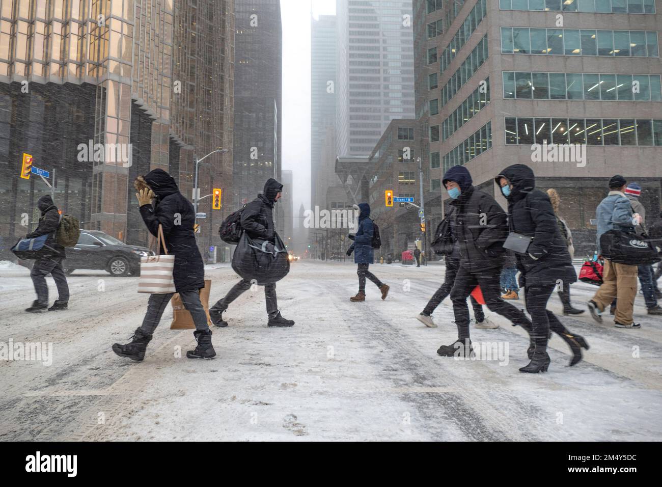 Toronto, Canada. 23 December 2022. Pedestrians navigate icy conditions ...