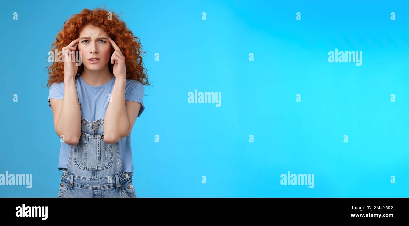 Confused panicking young distressed redhead curly girlfriend frowning ...