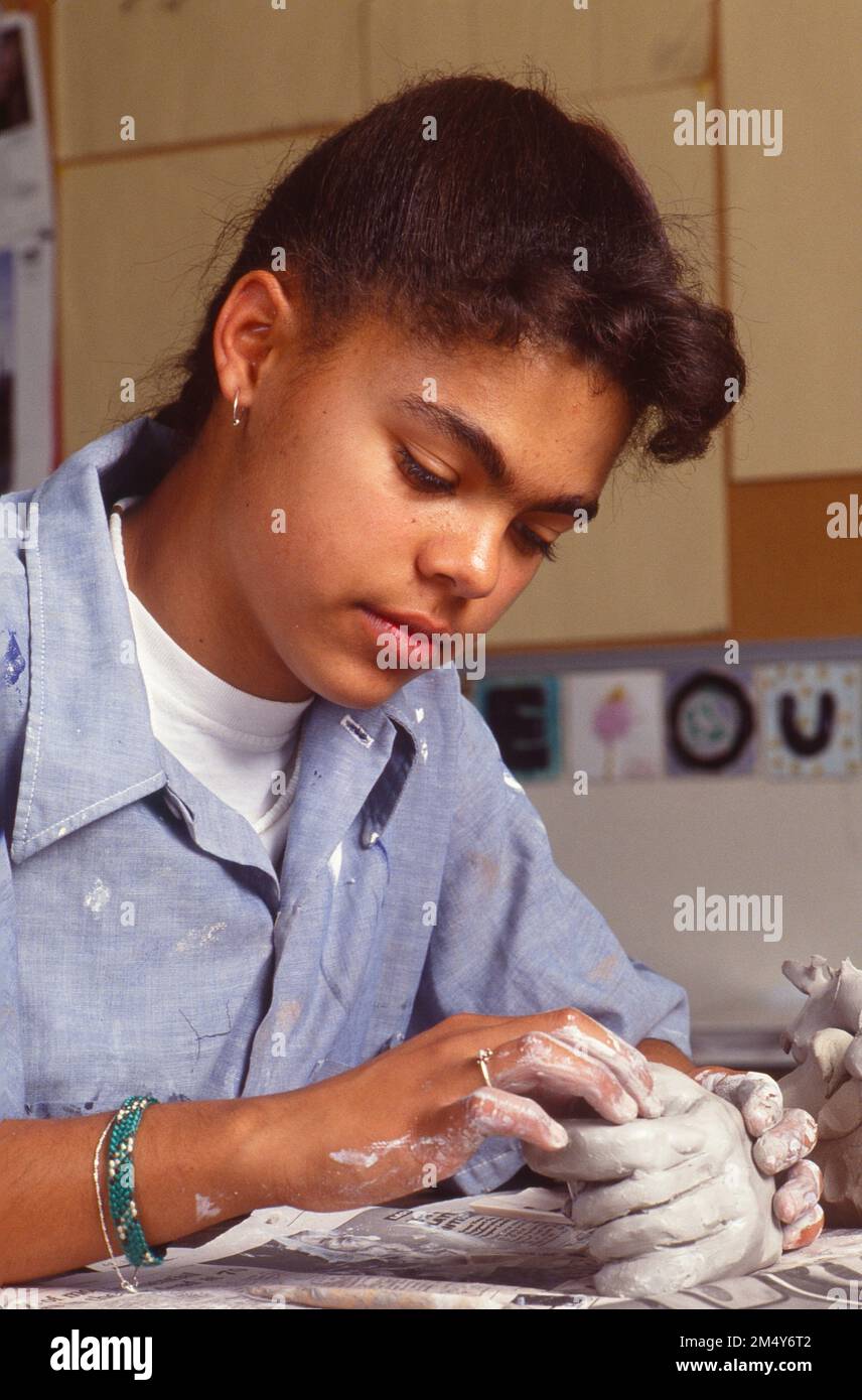 African-American teenage girl using putty in school art class Stock ...