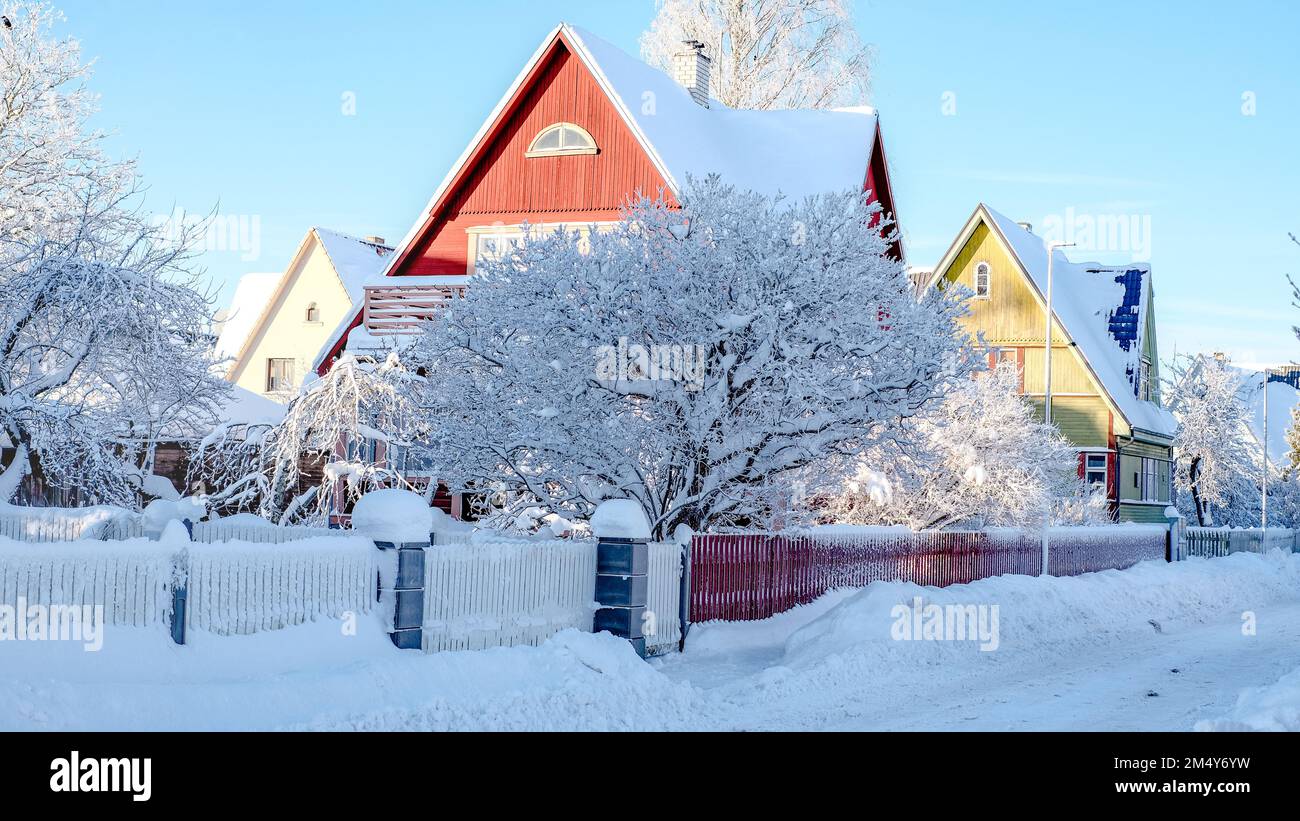 Winter fairy-tale landscape on the street with houses with a triangular ...