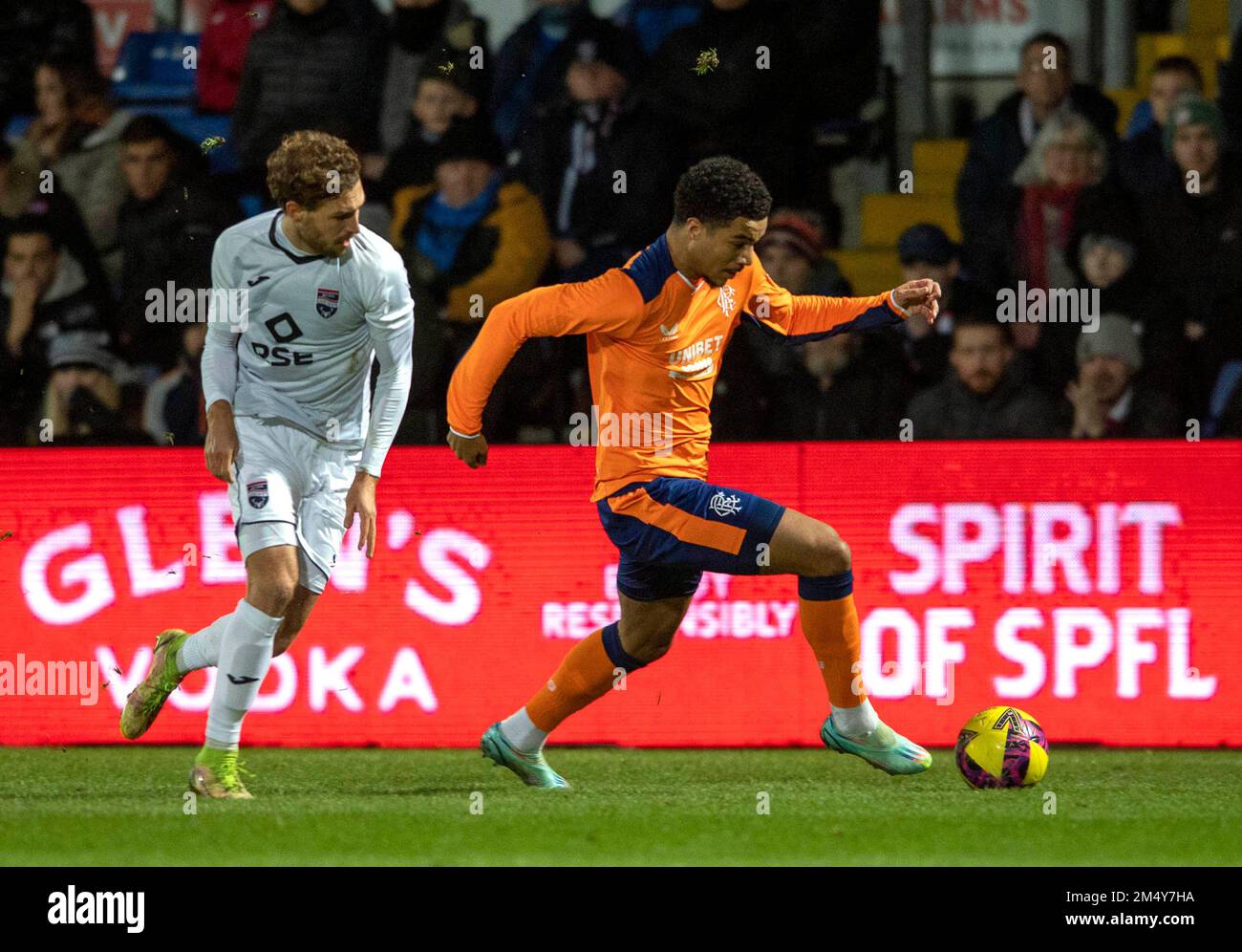 Rangers' Malik Tillman (right) gets past Ross County's Alex Iacovitti ...