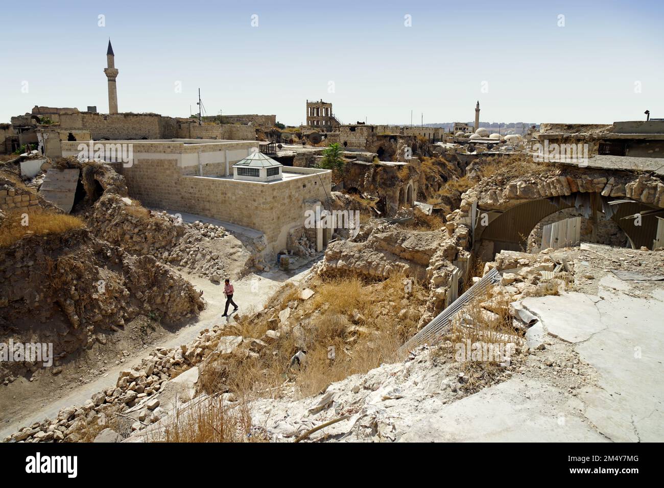 A man walks through the ruins of Aleppo's ancient souk, (Souq al-Madina). It suffered extensive ...