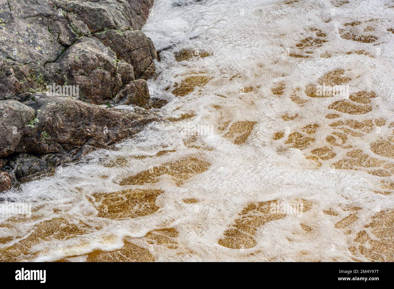 The Sand River with foam and bubbles below a waterfall, Lake Superior ...