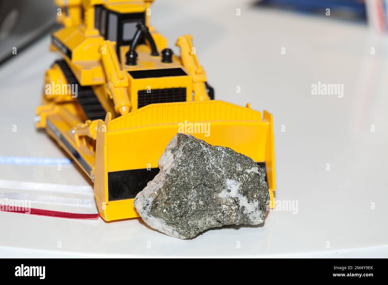 Toy Backhoe Pushing A Stone From The Mine Stock Photo - Alamy