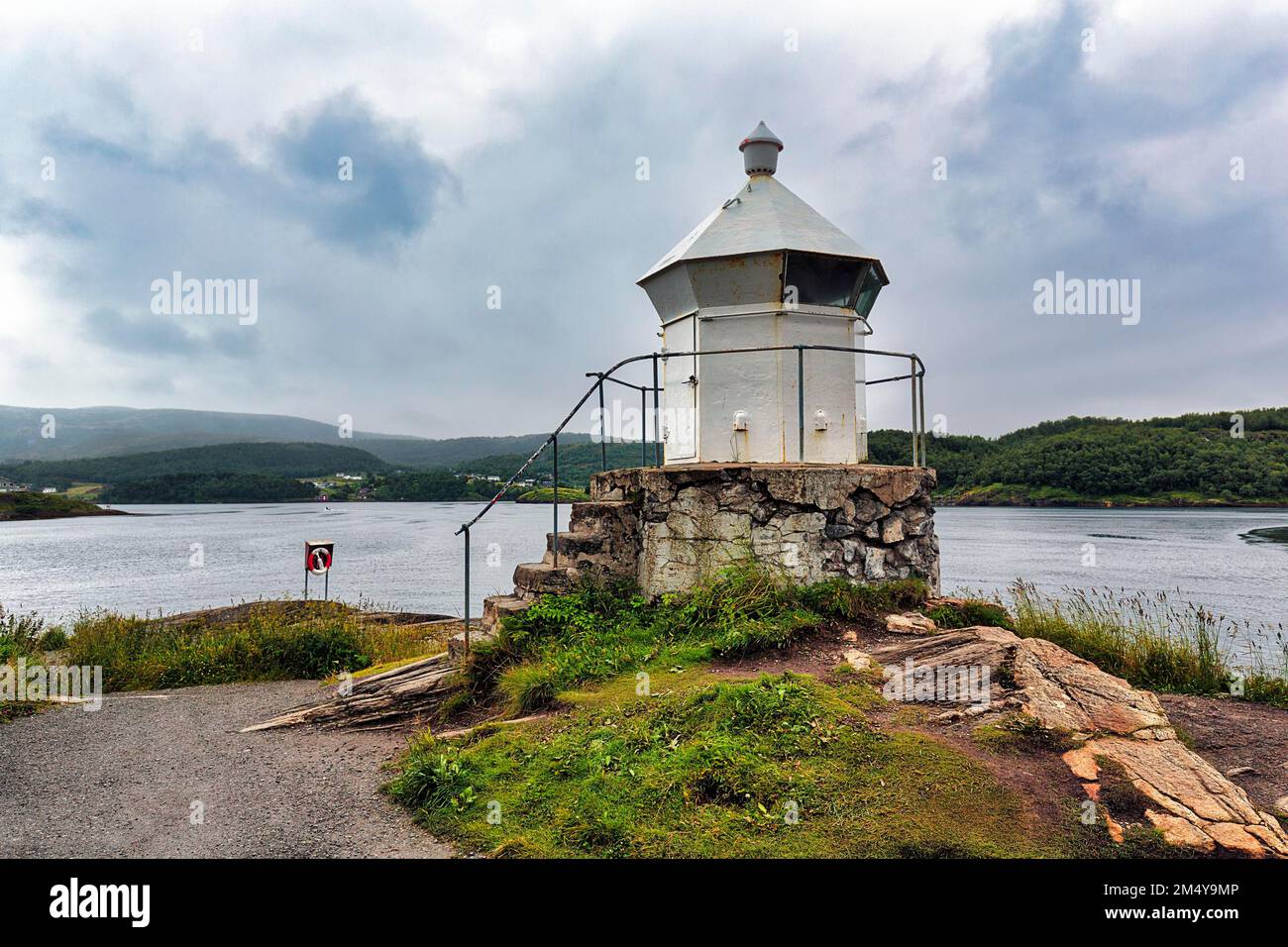 Small white lighthouse at the tidal stream Saltstraumen, cloudy sky ...