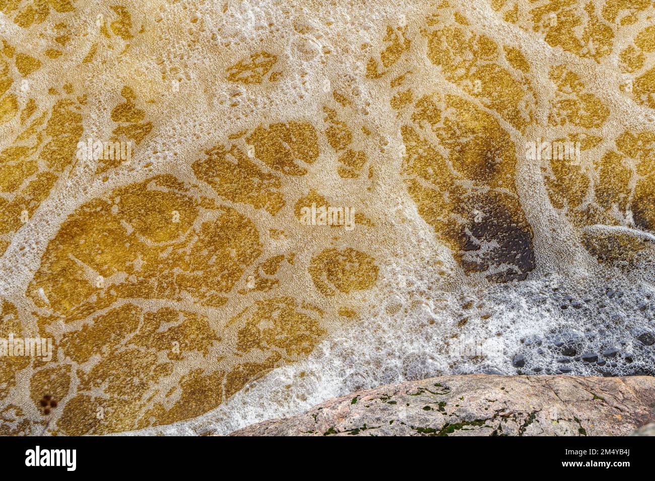 Foam patterns below a waterfall, the Sand River, Lake Superior ...