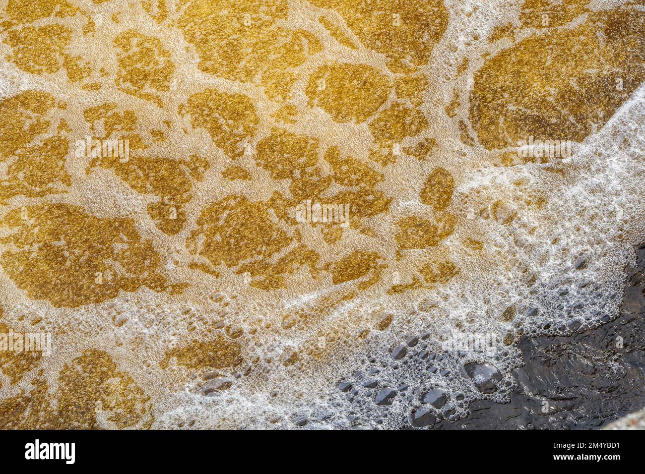 Foam patterns below a waterfall, the Sand River, Lake Superior ...