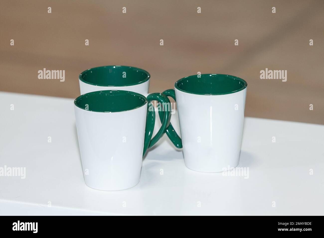 Set Of Three Mugs White With Green Stock Photo - Alamy