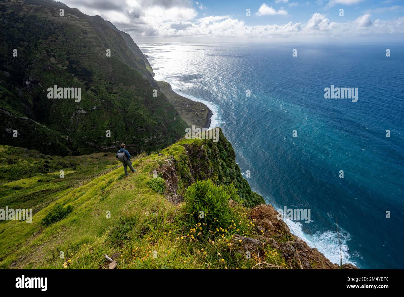 Tourist standing on a cliff, view of cliff with cliffs and sea, coastal ...