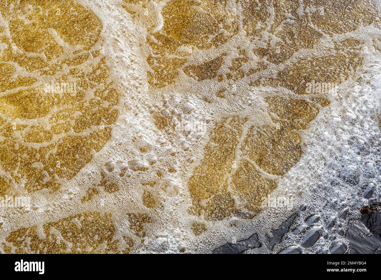 Foam patterns below a waterfall, the Sand River, Lake Superior ...
