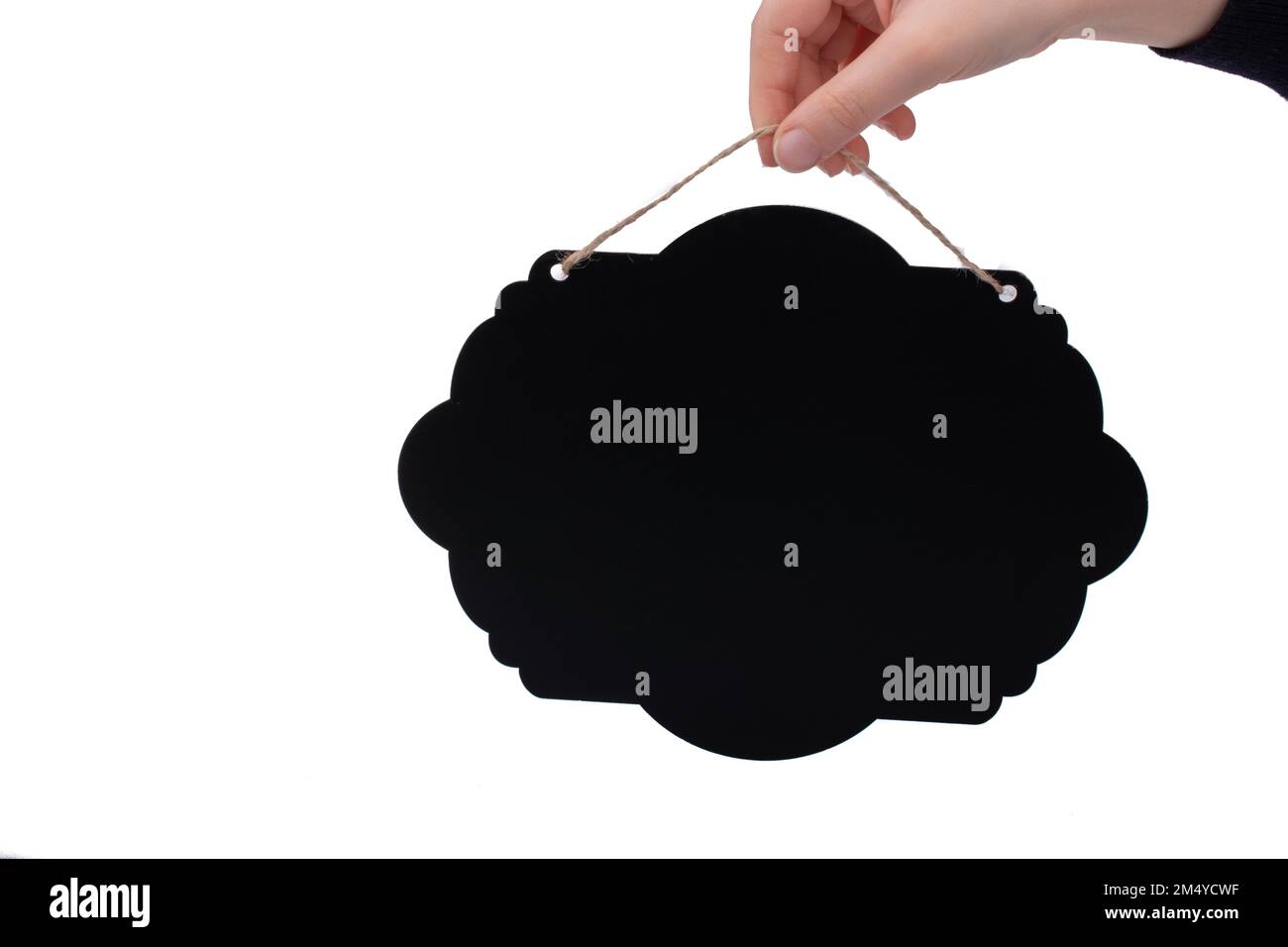 Black speech bubble shaped notice board in hand on white background ...