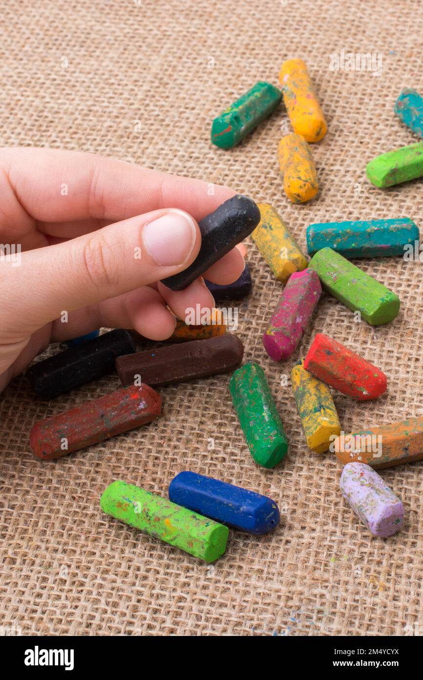 Used color crayons and a hand holding one Stock Photo - Alamy