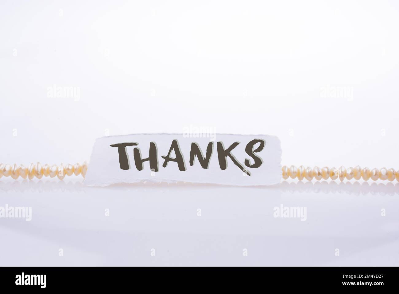 Thanks wording piece of paper placed on a white background Stock Photo ...