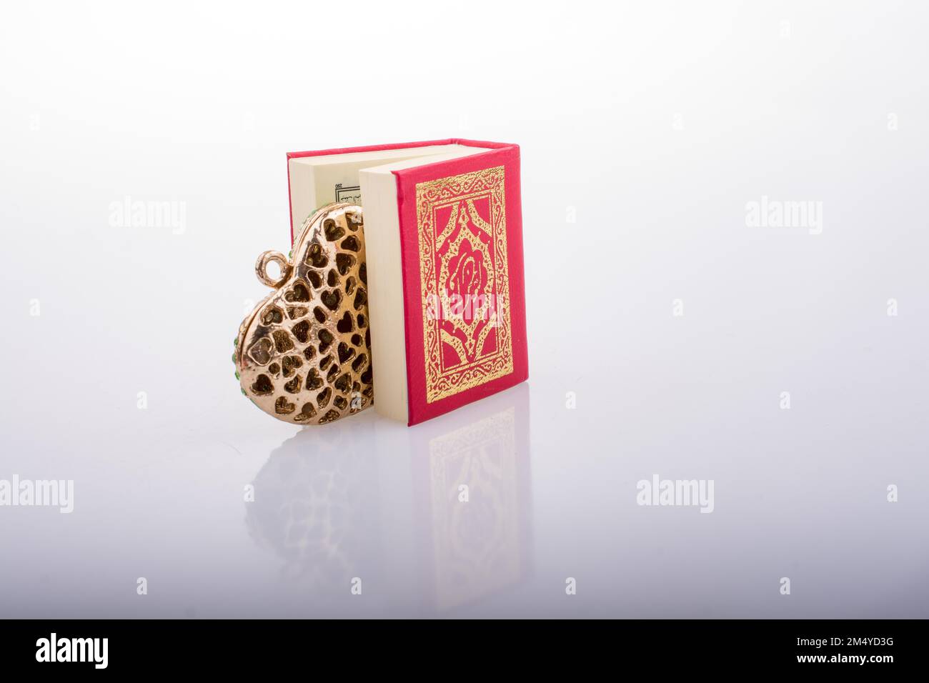 Heart shape and Islamic Holy Book Quran mini size Stock Photo - Alamy