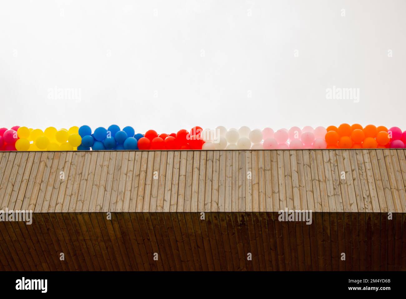 Color balloons on the roof of a building Stock Photo - Alamy